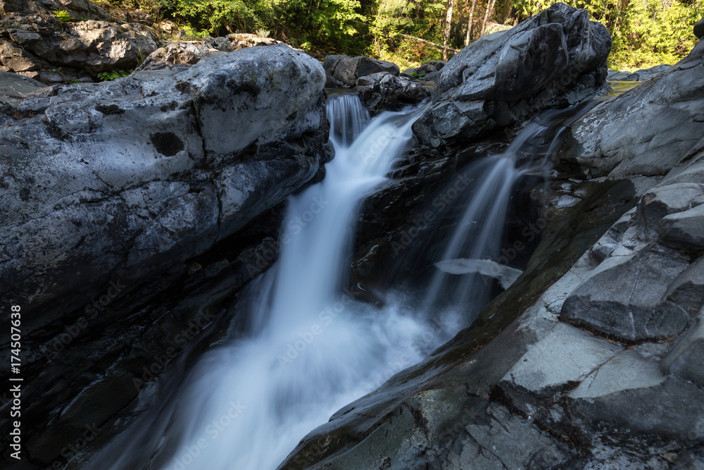 Water spring running down the smooth rocks in a beautiful canyon. Taken ...
