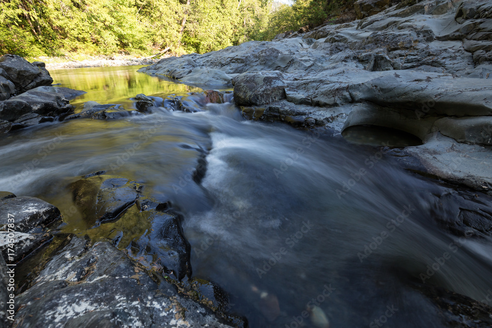 Water spring running down the smooth rocks in a beautiful canyon. Taken ...