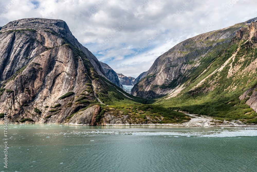 Valley between two mountain peaks with icy ocean foreground Stock Photo ...
