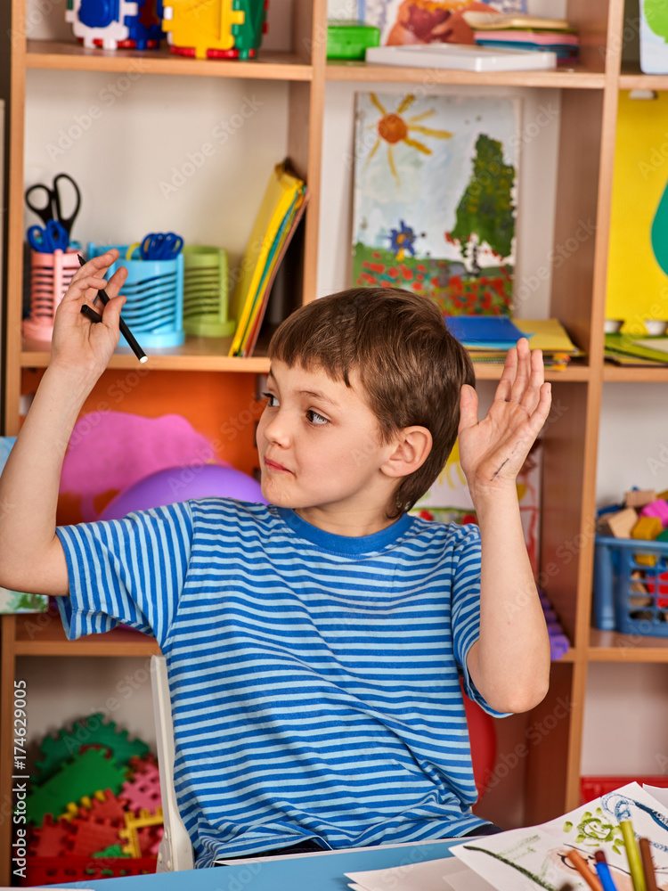Small student boy painting in art school class. Child drawing by paints ...