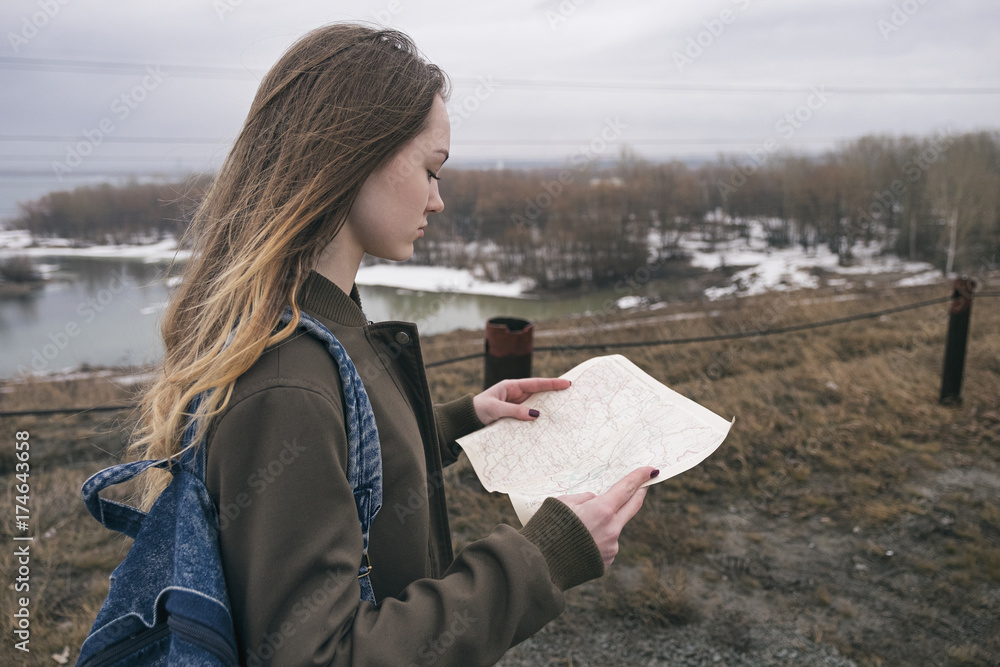 Side view of young traveler holding map Stock Photo | Adobe Stock