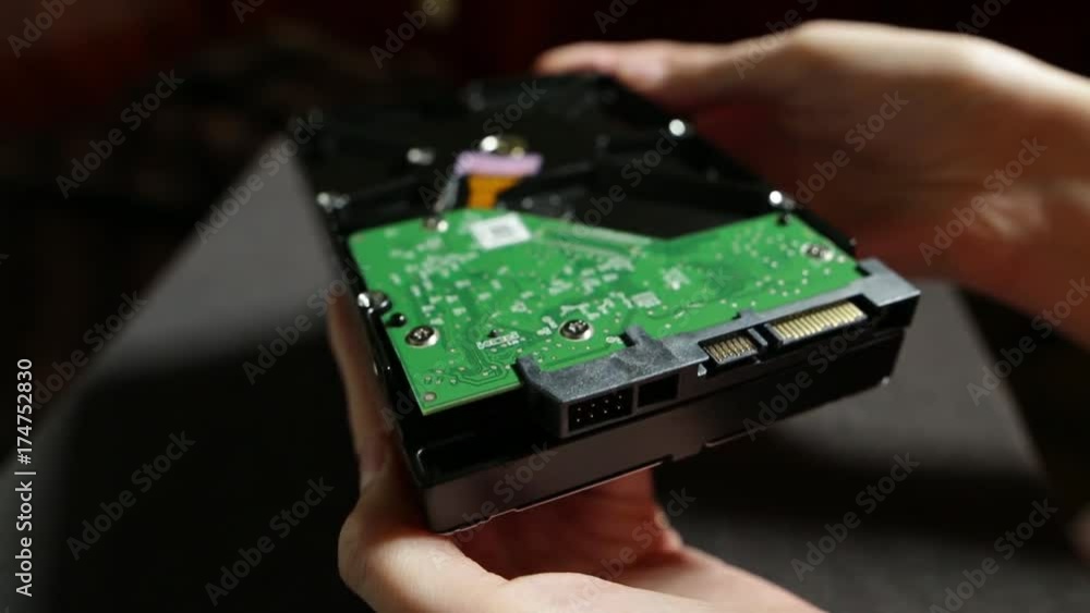 Hard disk drive close up stock footage. Female hands showing the ...