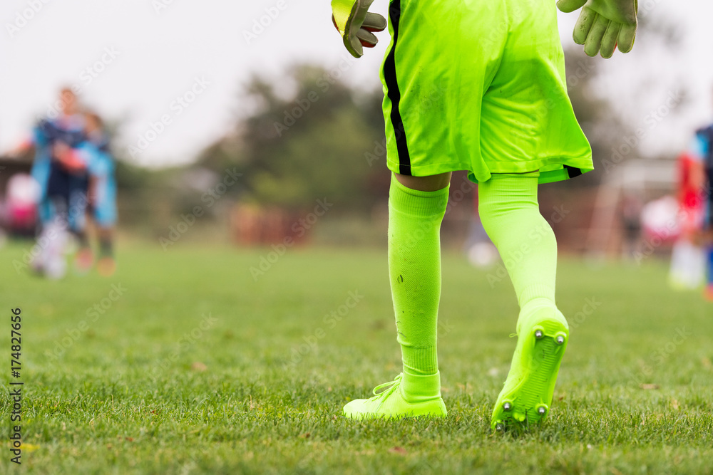 Kids soccer football - little goalkeeper in green goalkeeper jersey at ...