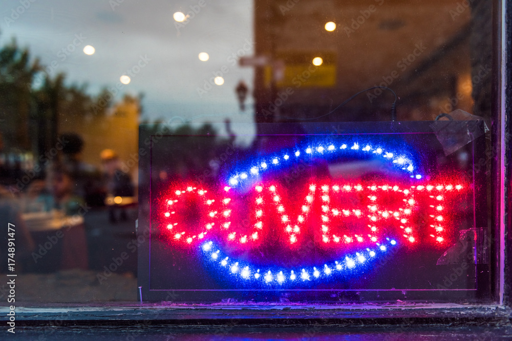 French ouvert open sign for store shop or restaurant glowing in the ...