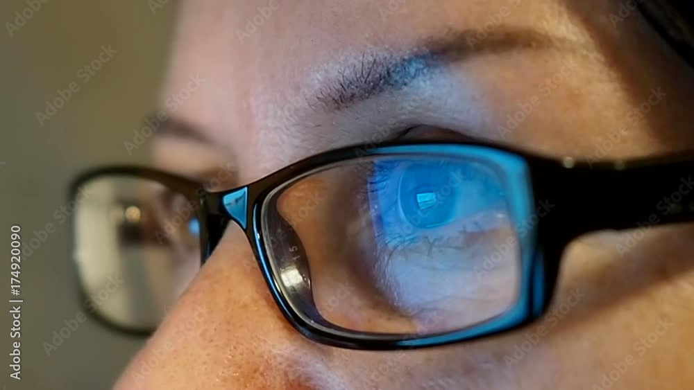 Eyes girls with glasses frame looking at the screen. The reflection of ...