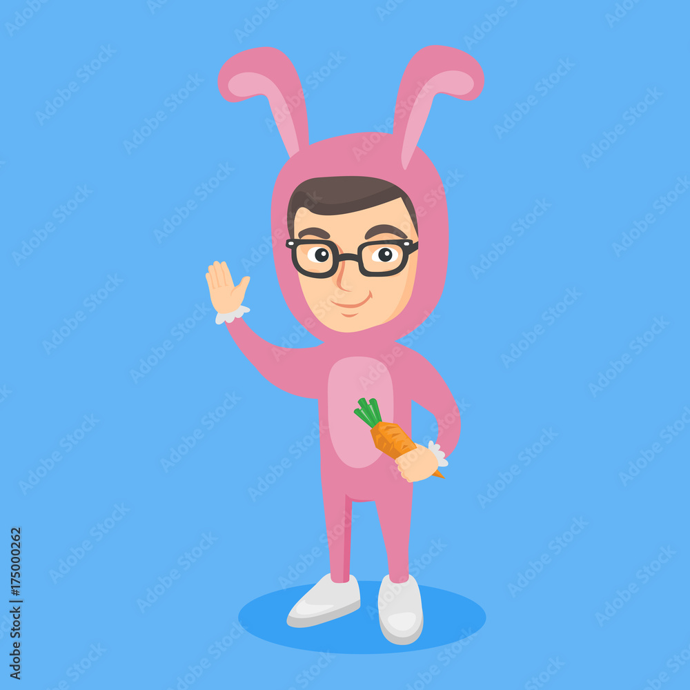Little caucasian boy wearing a rabbit costume and holding a carrot ...