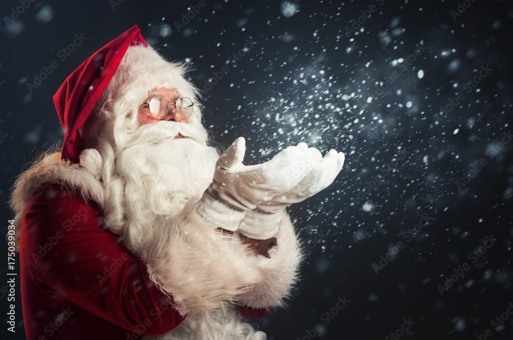 Santa Claus blowing magic snow of his hands Stock Photo | Adobe Stock