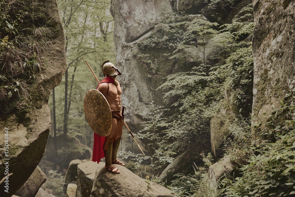 Strong male model wearing outfit of ancient Roman warrior posing with ...