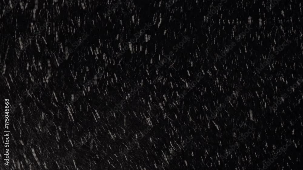 Heavy snowfall at dark night. Winter blizzard against the black Stock ...