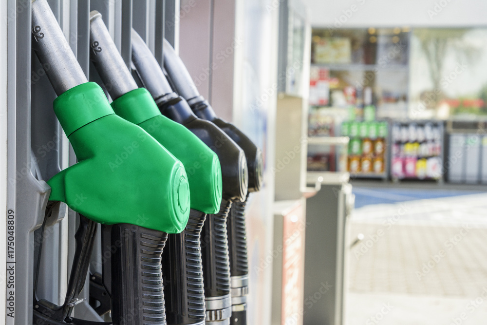 Gasoline and diesel distributor at the gas station. Gas pump nozzles ...