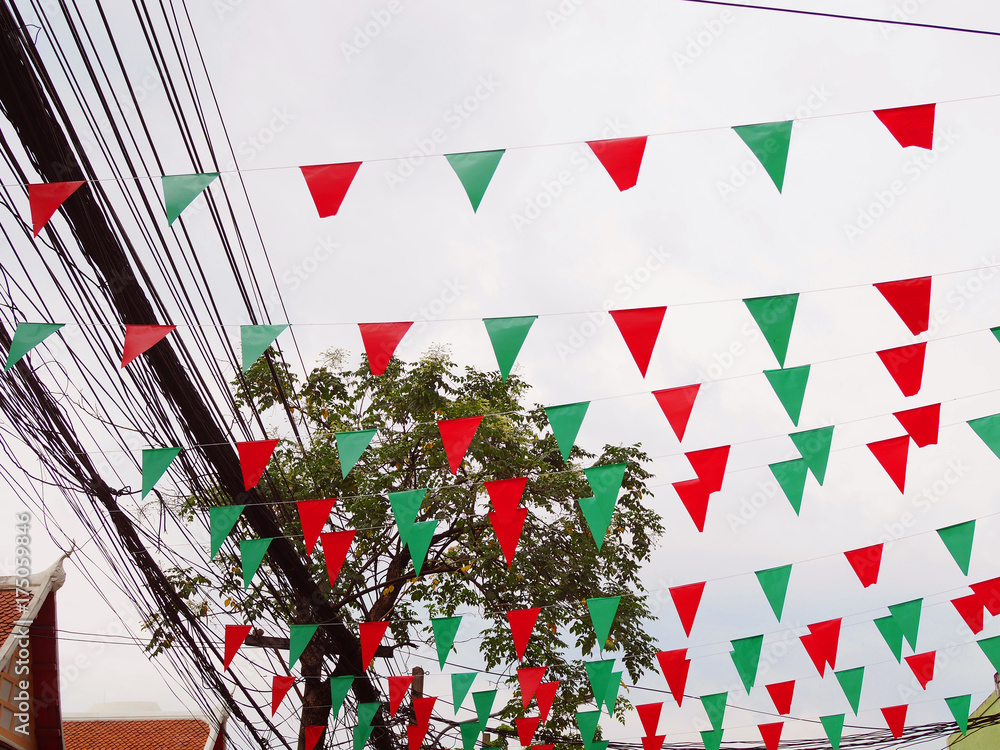 Green and red triangle cloth flag pieces hanging on thread for Thai ...