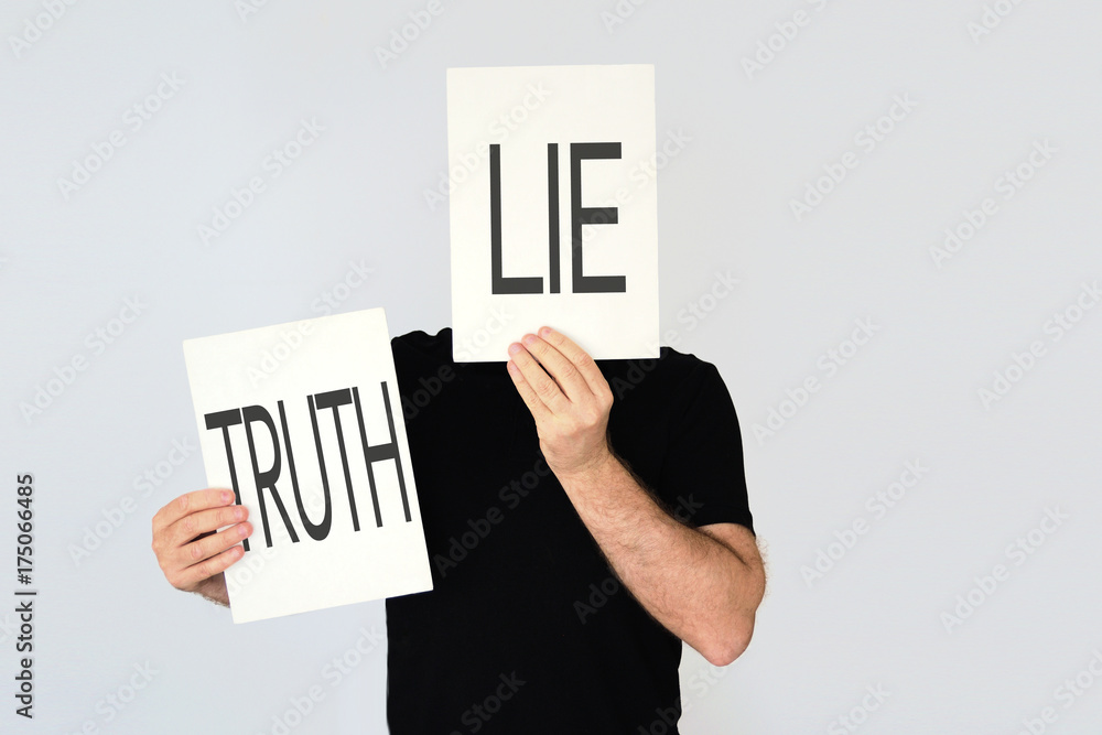 Man holding two cards with the words Lie and Truth representing ...
