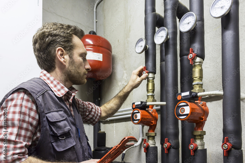 plumber at work installing a circulation pump Stock Photo | Adobe Stock