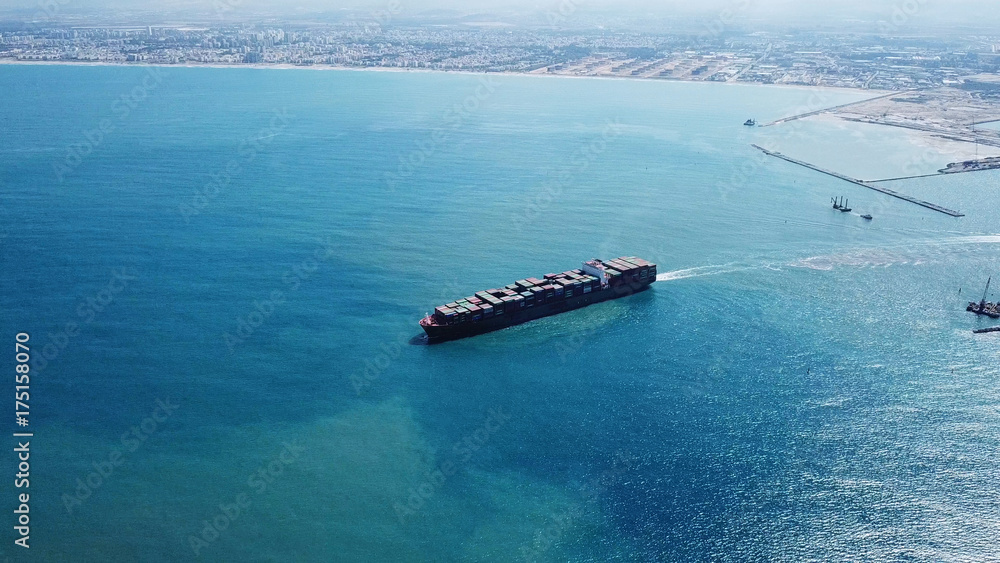 Huge large mega container ship sails on open water fully loaded with ...