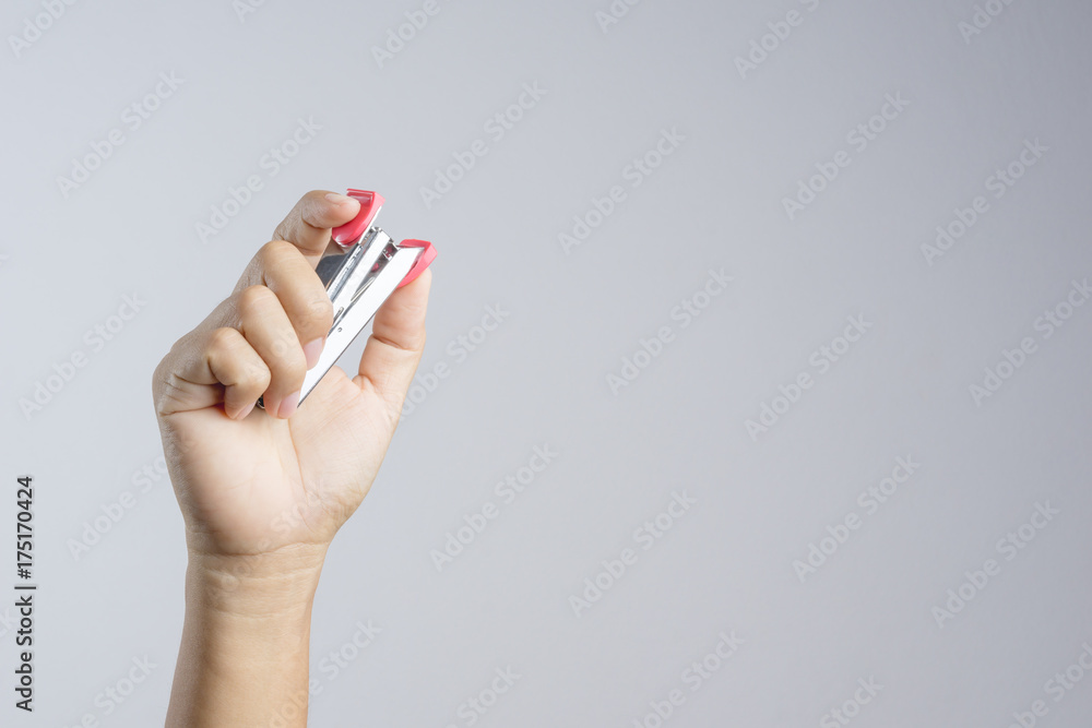 Hand holding stapler, an office supplies for stapling pages of paper or ...