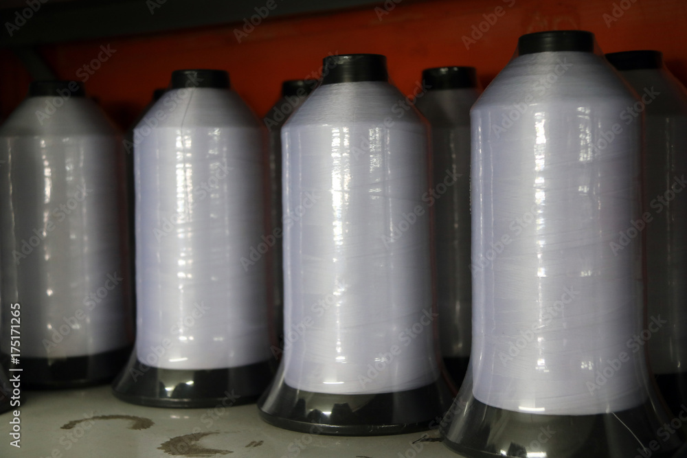 Stock of white color thread on the shelf. White color of thread, row on ...