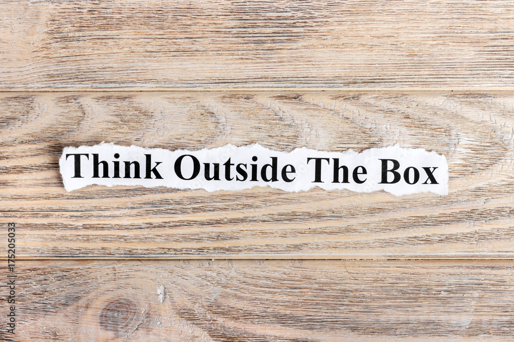 Think Outside The Box text on paper. Word Think Outside The Box on torn ...