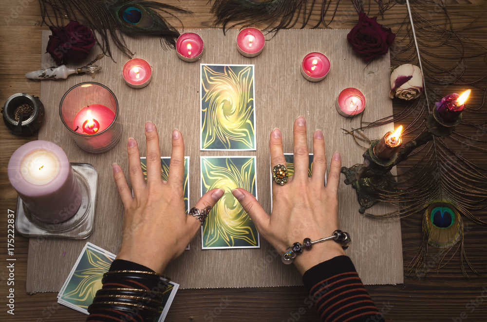 Tarot cards on the paranormal table and fortune teller female hands ...