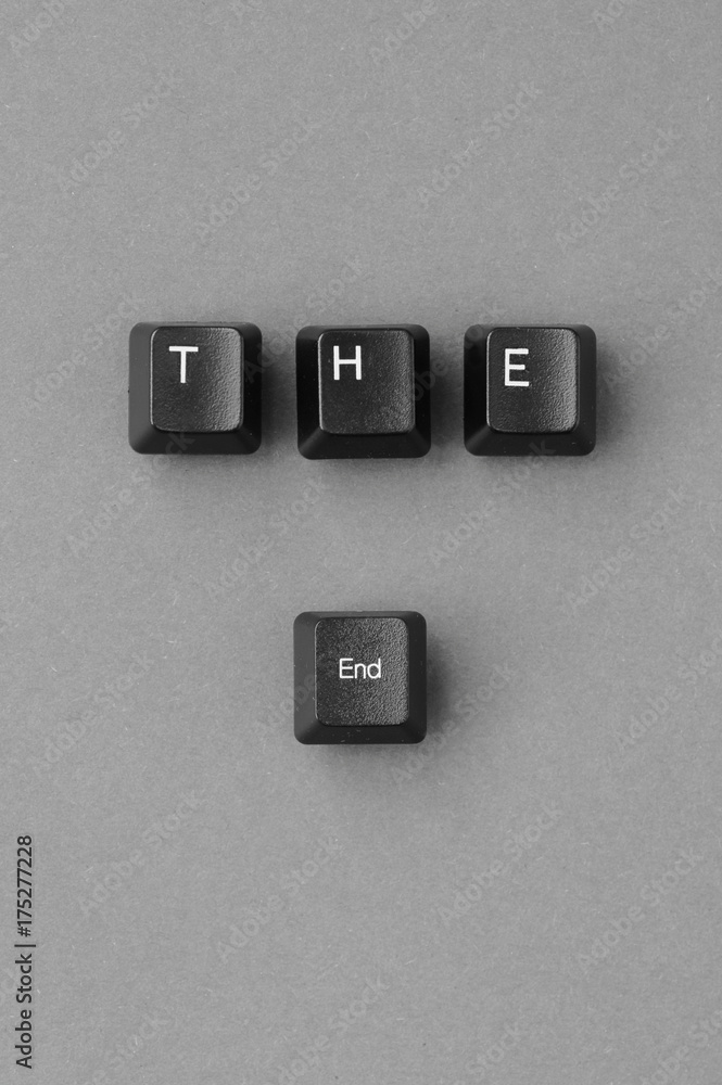 'The end' written with computer keyboard keys on a paper background ...