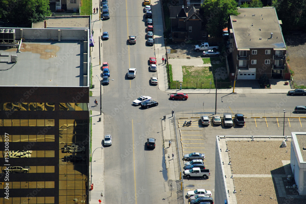 A police car and a car meet in the middle of an intersection. A ...
