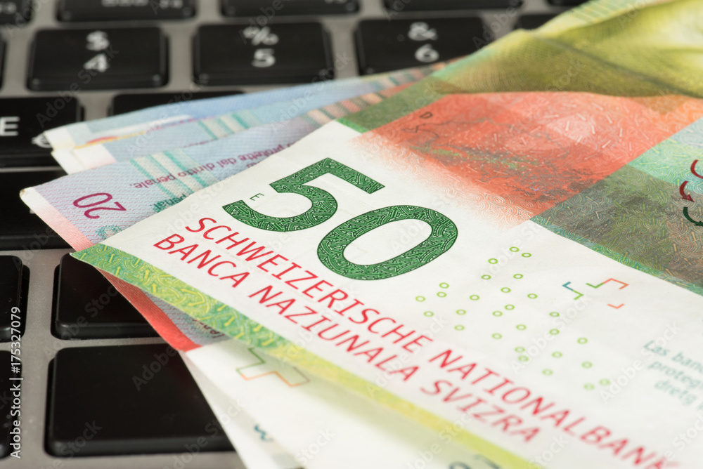 Schweizer Franken und ein Computer Stock Photo | Adobe Stock