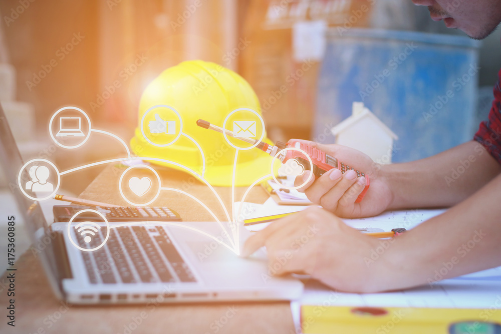Engineer builder in hardhat using mobile phone and walkie talkie or ...