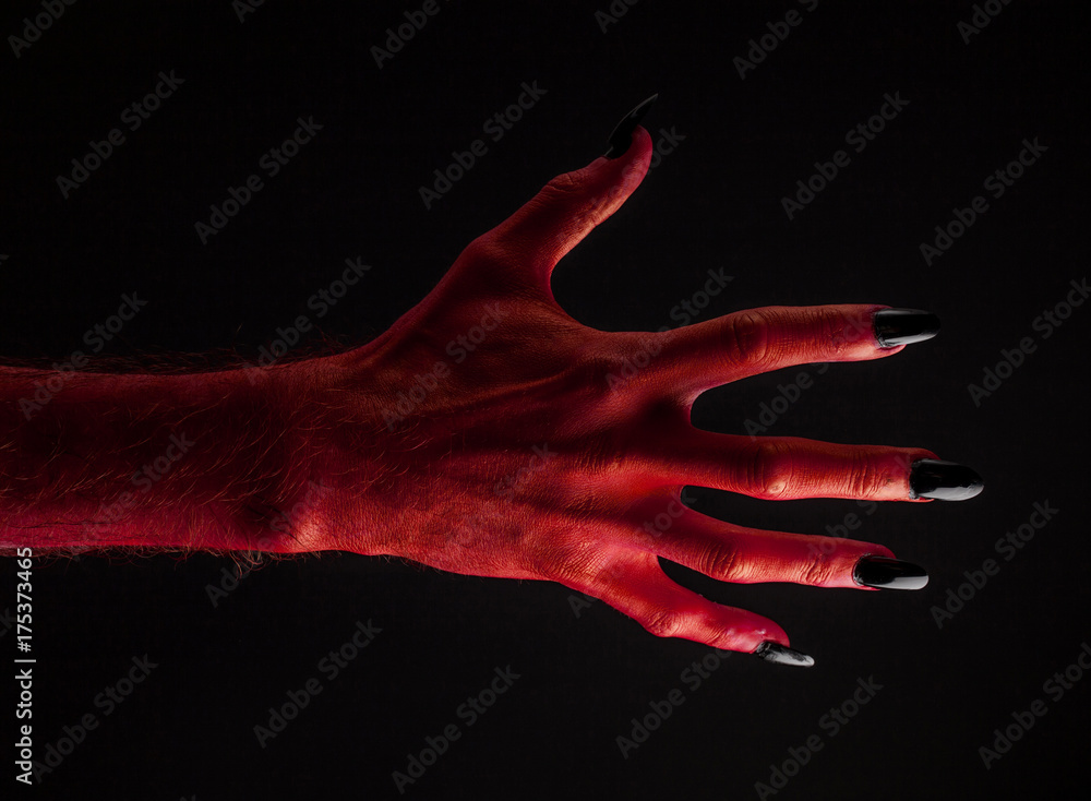 Red devil creepy halloween hand on a black background Stock Photo ...