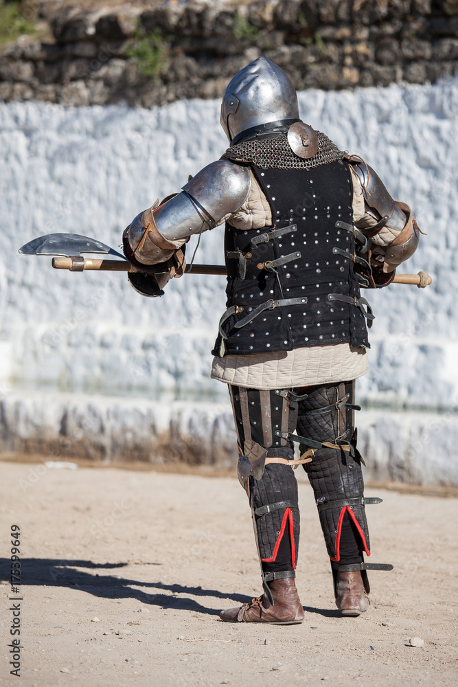 Men in a medieval battle. They are protected by armors from the 14th ...