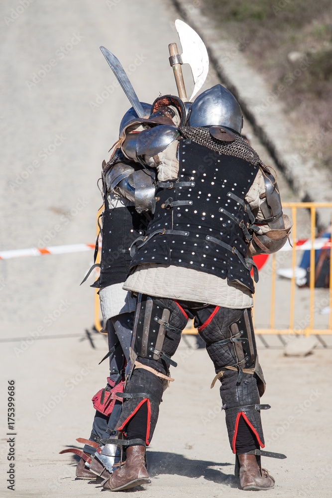 Men in a medieval battle. They are protected by armors from the 14th ...