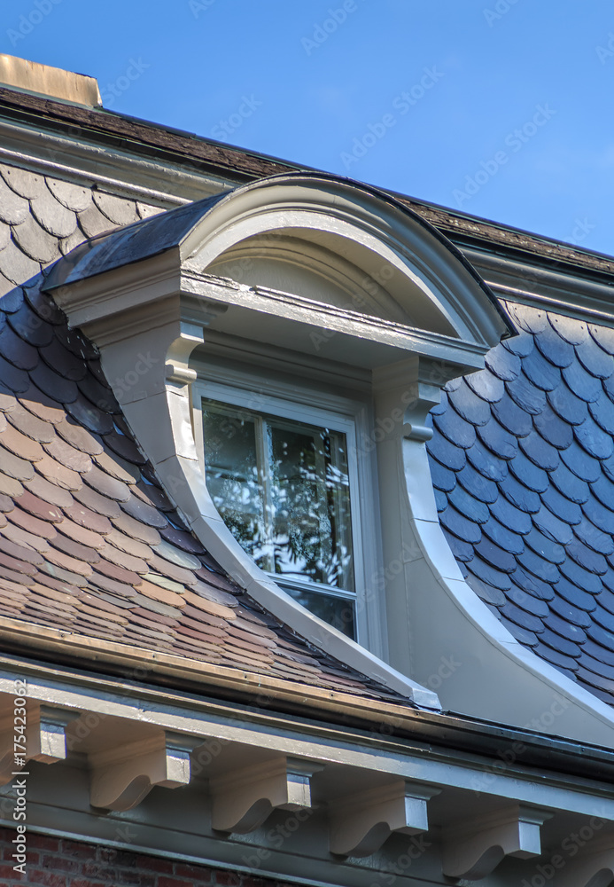 A dormer window with a doomed casement is set in the side of a historic ...