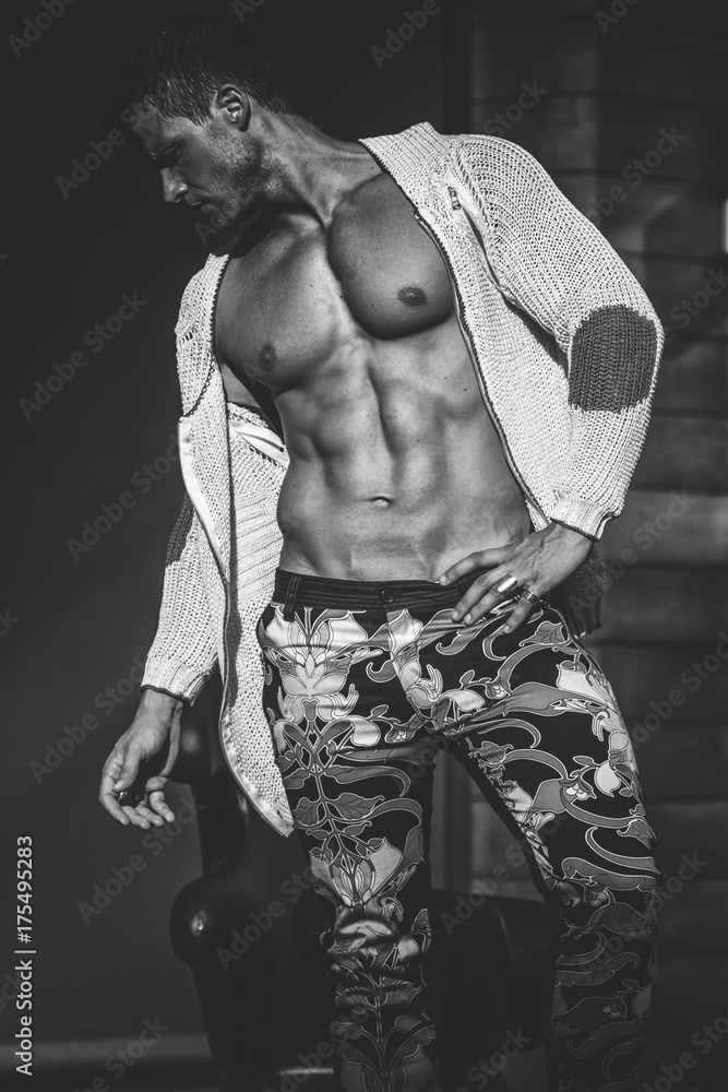 Muscular handsome man posing in unzipped jacket Stock Photo | Adobe Stock