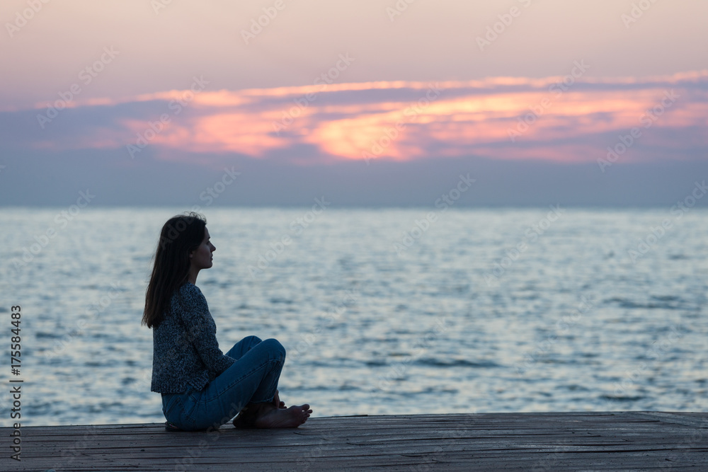 A Girl Sitting Alone In The Sunrise