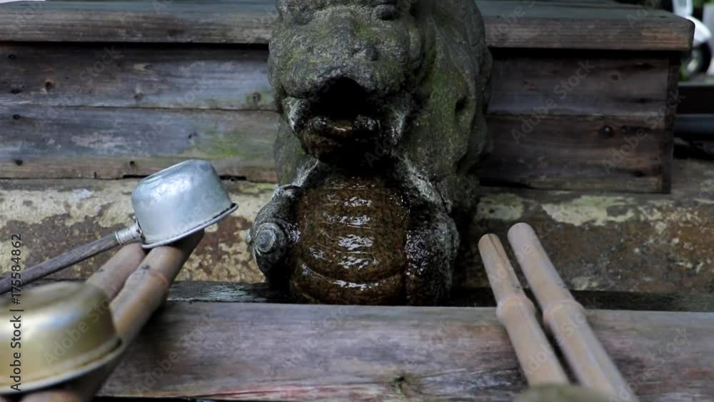 a ladle at the well with a water spout, shrine at Osaka castle area ...