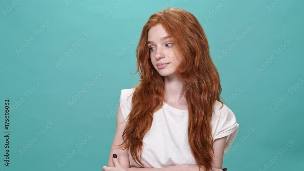 Shy mystery ginger woman in t-shirt posing with crossed arms and ...