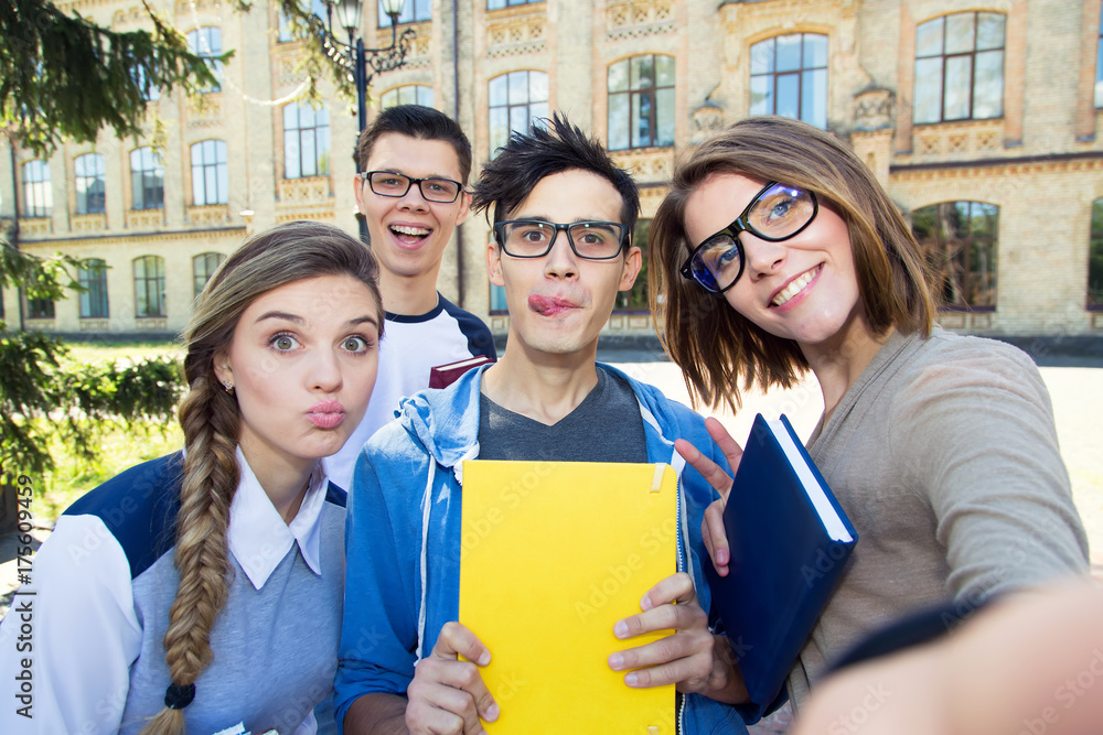 Happy four student friends. Cheerful self photo of a group of students ...