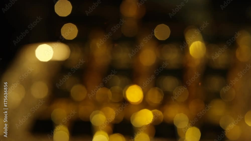 Shimmering golden particles reflected from out of focus stack of gold ...