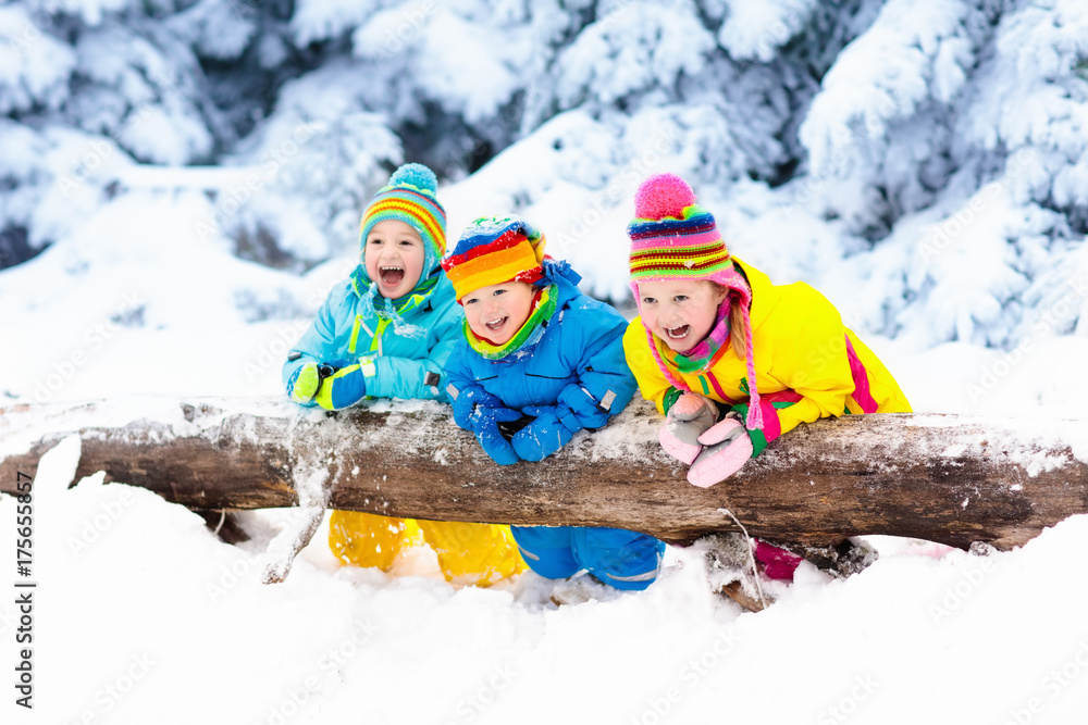 Kids playing in snow. Children play outdoors in winter snowfall. Stock ...