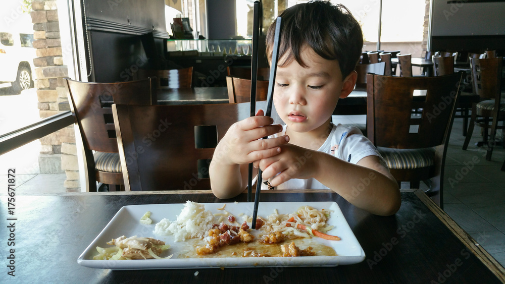 Cute Young Chinese and Caucasian Boy Learning To Use Chopsticks At ...