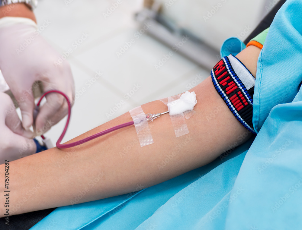 Blood donor at donation, transfusion. Close up right arm of a business ...