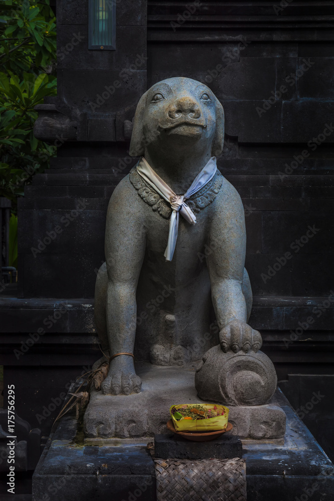 Dog statue at the entrance of a hinduist temple in Bali, Indonesia ...