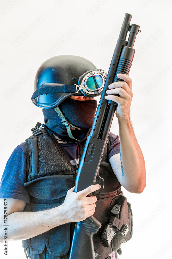 man armed with balaclava and bulletproof vest, gun and shotgun ...