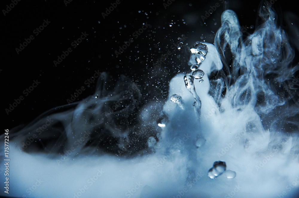 Boiling water splash with steam on black background closeup Stock Photo ...