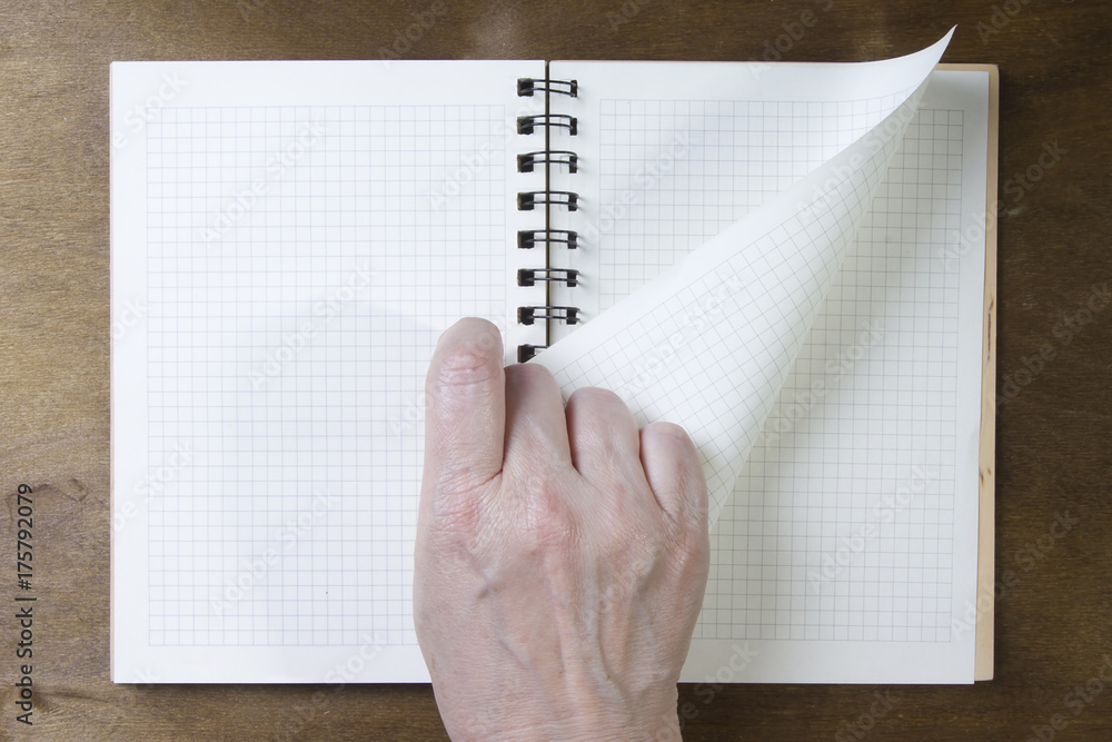 Hands turn pages of the notebook Stock Photo | Adobe Stock