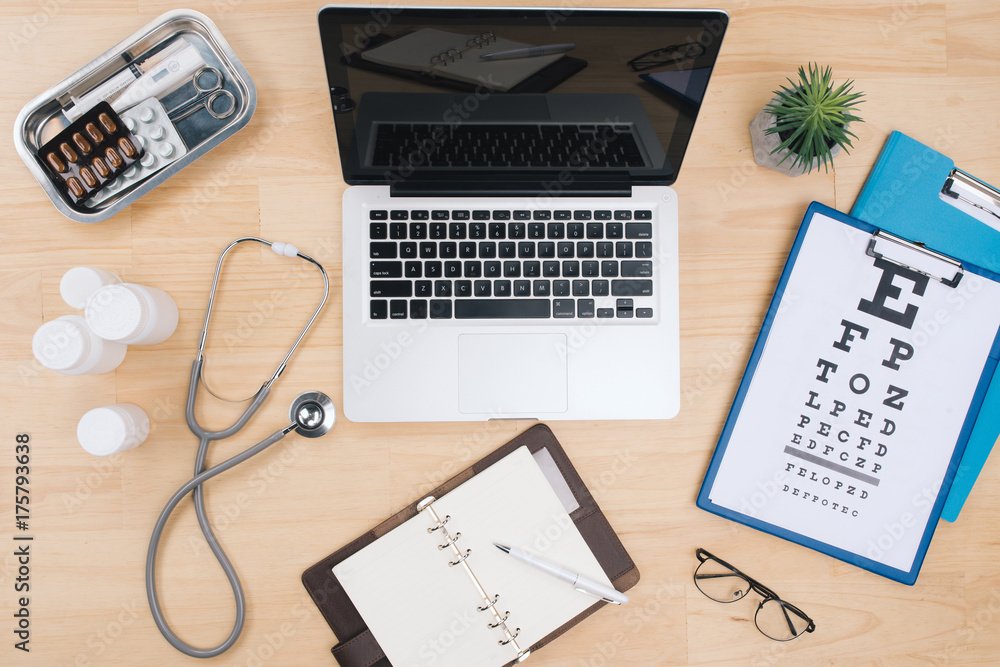 Top view of doctor desk table with stethoscope and notebook with a ...