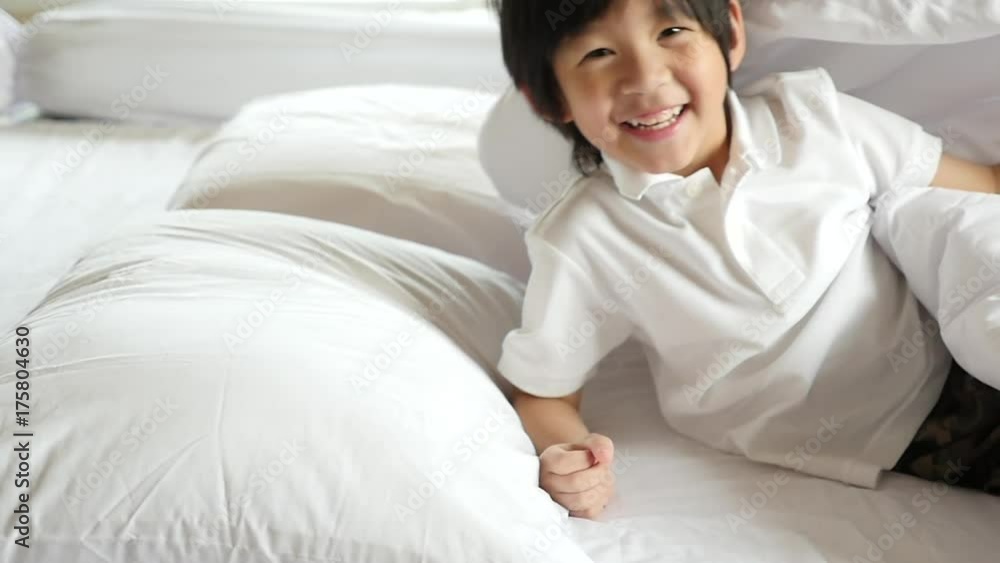 Cute asian child playing hide and seek on white bed slow motion Stock ...