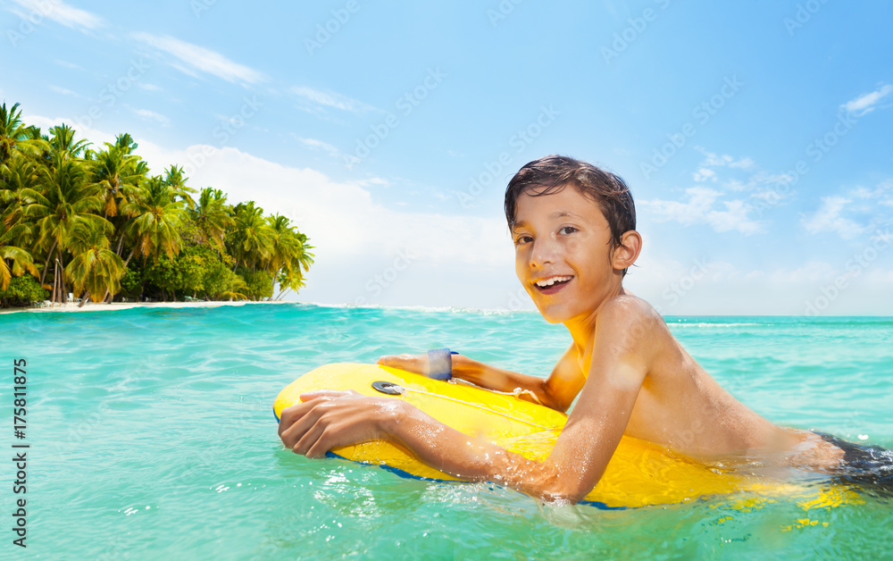Boy swim on body board in the sea and smile Stock Photo | Adobe Stock