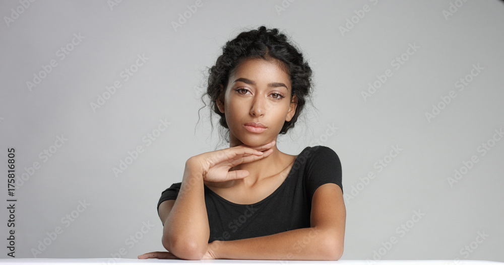 Attractive young Middle Eastern model touching her pretty face with ...