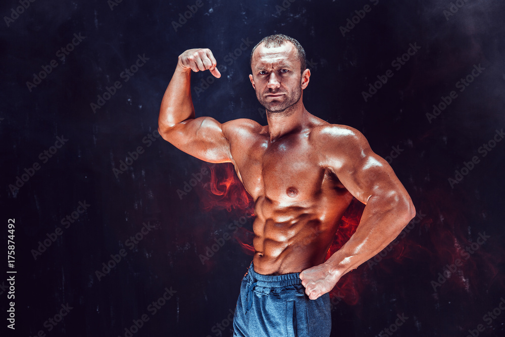 Strong bald bodybuilder with six pack. Strong bodybuilder man with ...