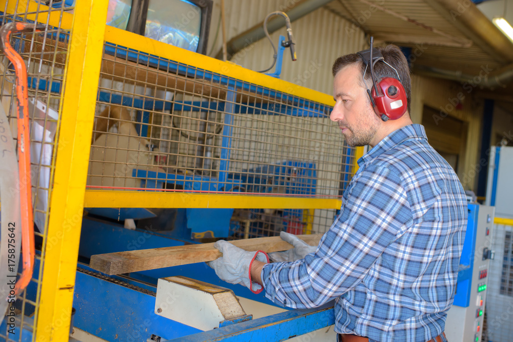 sawmill employee working with wood tools and machinery Stock Photo ...