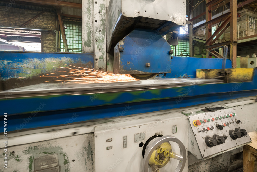 Work of an industrial surface grinding machine. Grinding of a flat ...